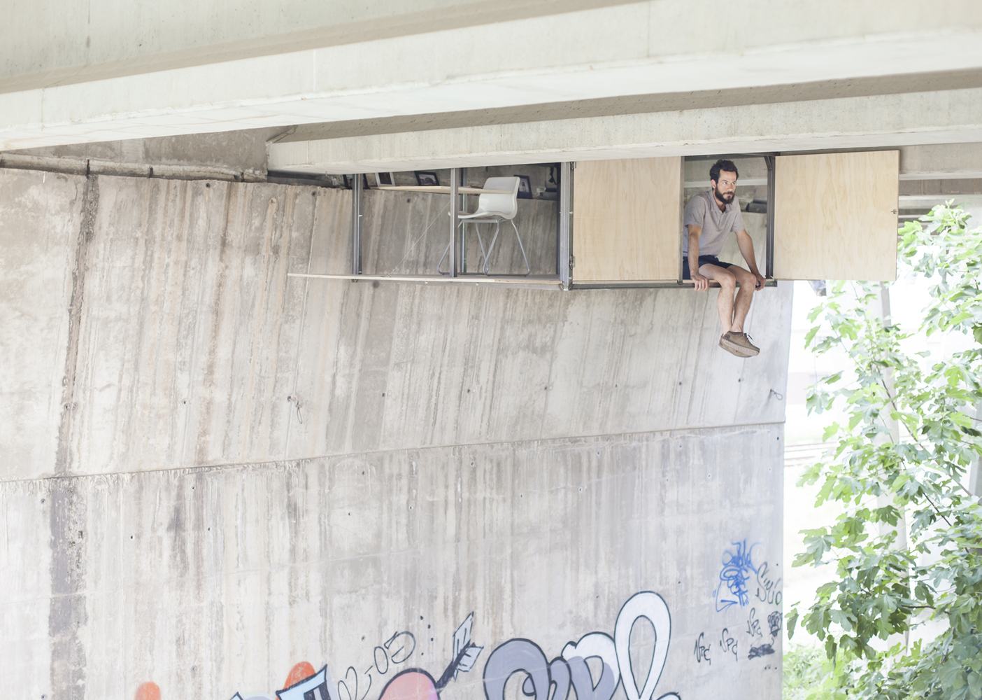 Gallery of Hidden Studio Beneath a Busy Bridge Provides Creative ...