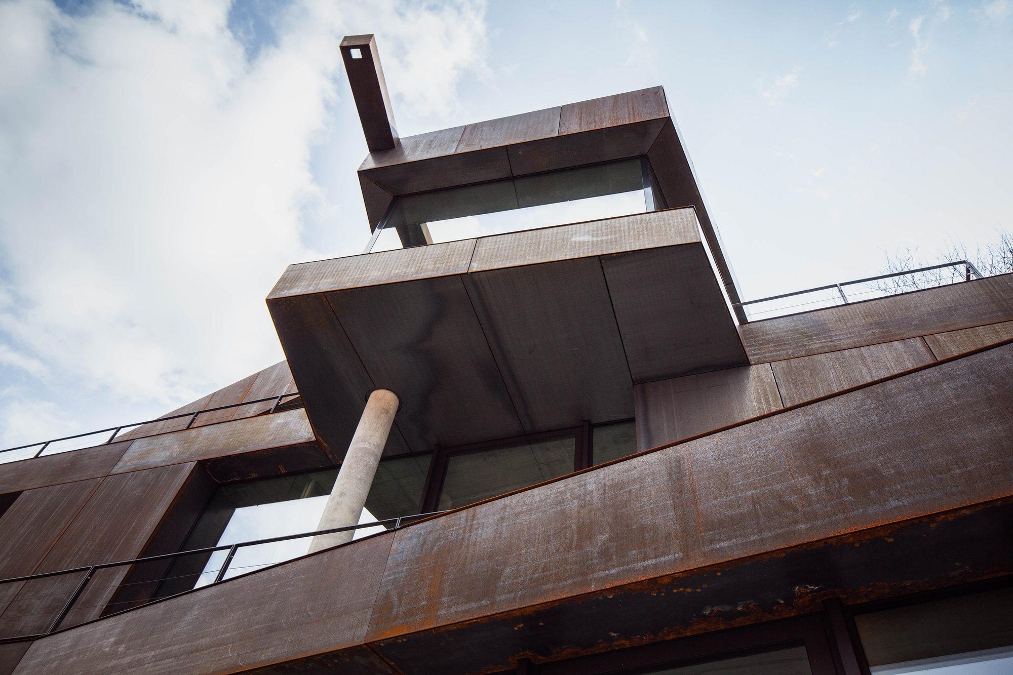 Gallery of “Concrete meets Corten” Residential and Office Building ...